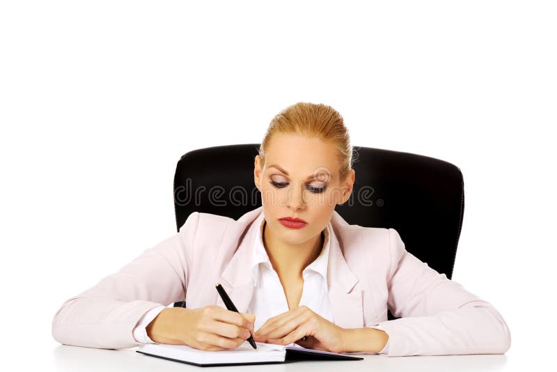 Pensive Business Woman Taking Notes Behind the Desk Stock Photo - Image ...