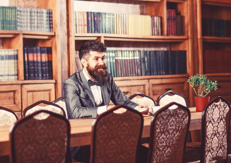 Pensive Businessman in Home Interior Behind Table and Bookcas Stock ...