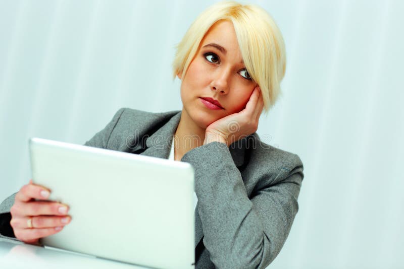 Pensive Businesswoman with Tablet Computer Looking Away Stock Photo ...