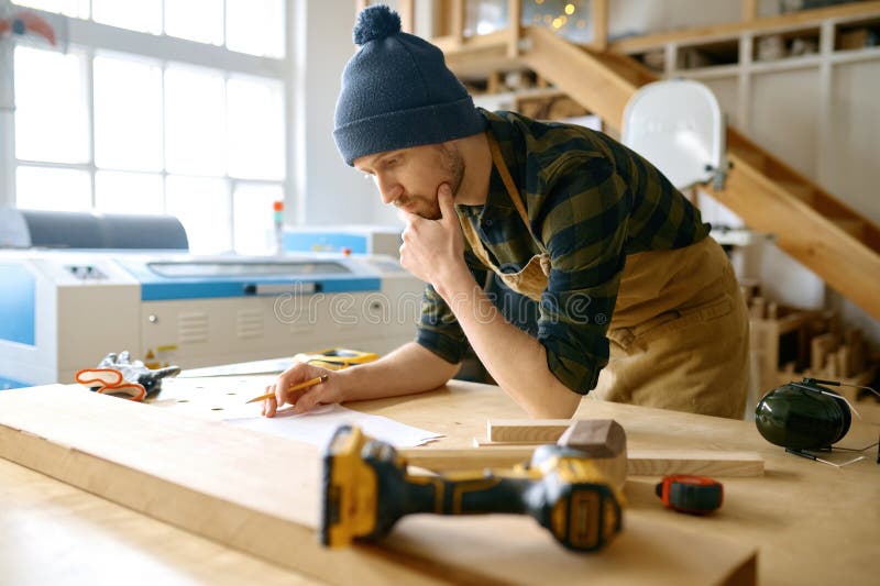 Pensive Carpenter Designer Looking at Plan Scheme on Work Table Stock ...