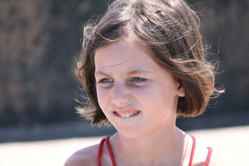 Pensive child biting lip stock image. Image of human - 12582443