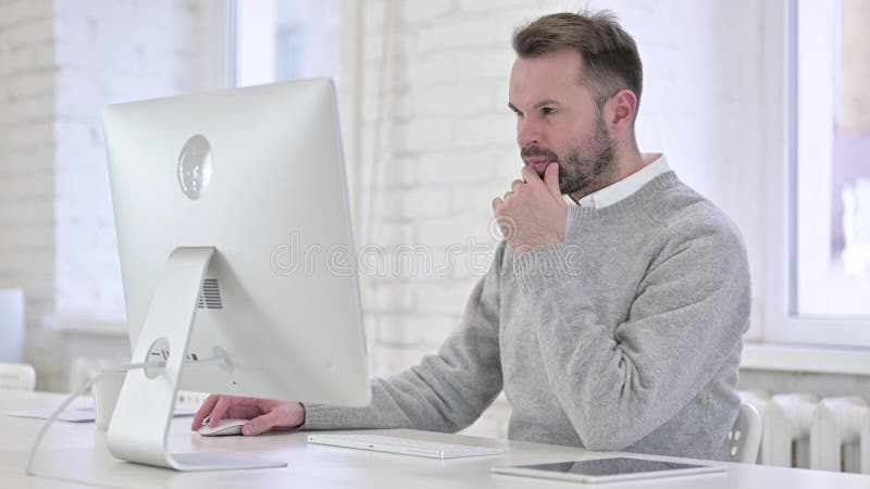 Pensive Creative Man Thinking and Working on Desktop Stock Photo ...
