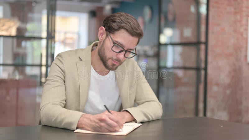 Pensive Young Man Writing on Paper, Thinking Stock Image - Image of ...