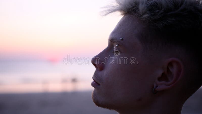Thoughtful Guy Looks into the Distance on the Beach during Sunset Stock ...