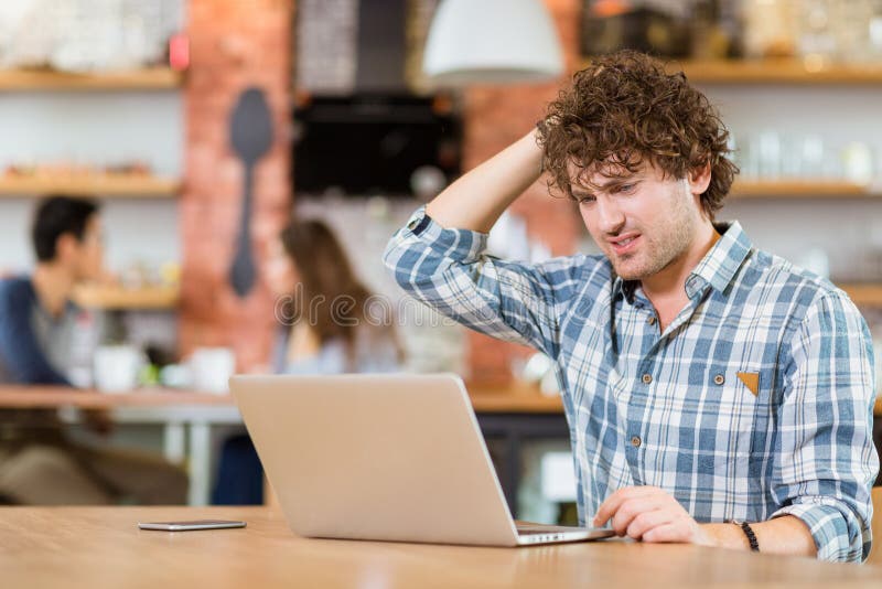 Pensive Guy Thinking and Using Laptop in Cafe Stock Photo - Image of ...