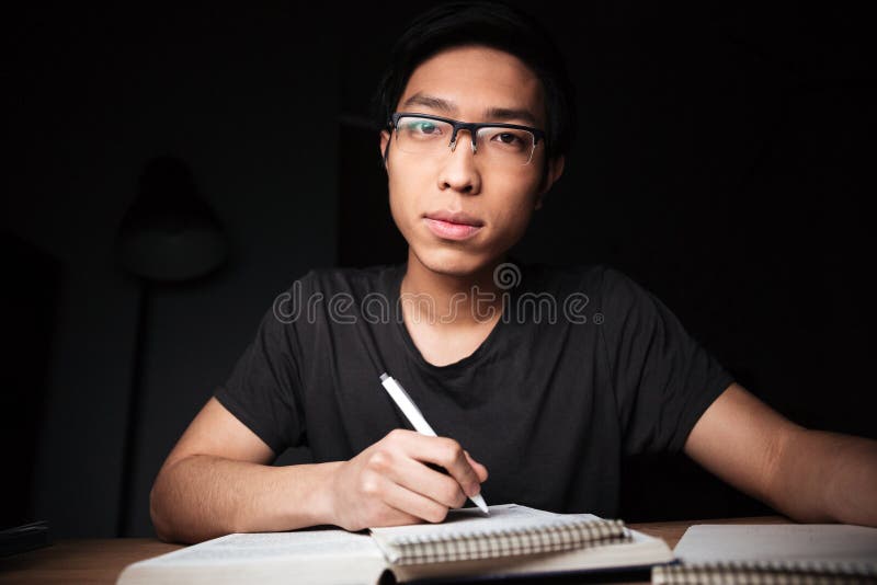 Pensive Man in Glasses Studying and Writing at the Table Stock Photo ...