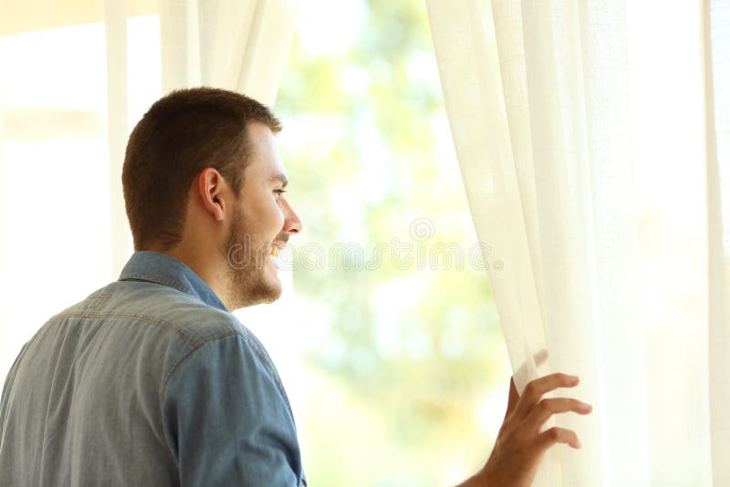 Young Man Opening Window Curtain At Home Stock Image - Image of white ...