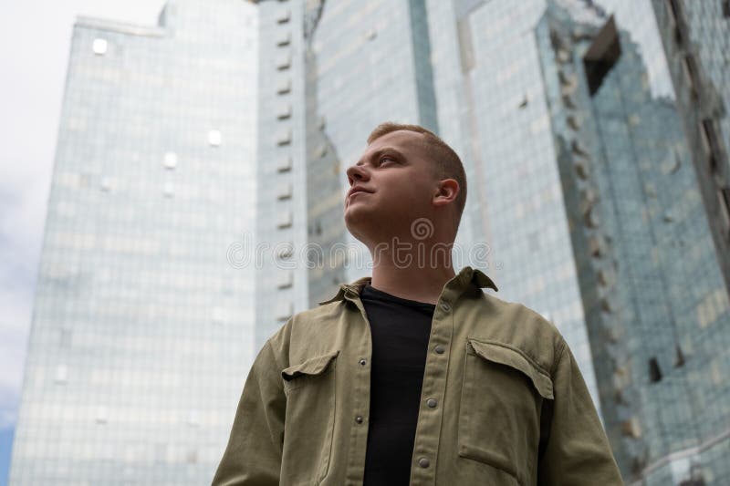 A Pensive Man Stands Against the Backdrop of a Skyscraper. Stock Image ...
