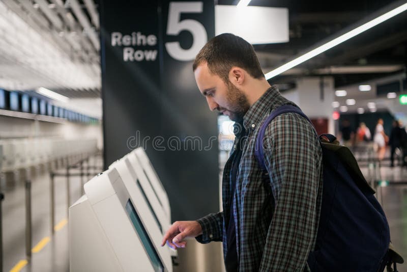 Pensive Man Using the Check-in Machine at the Airport Getting the ...