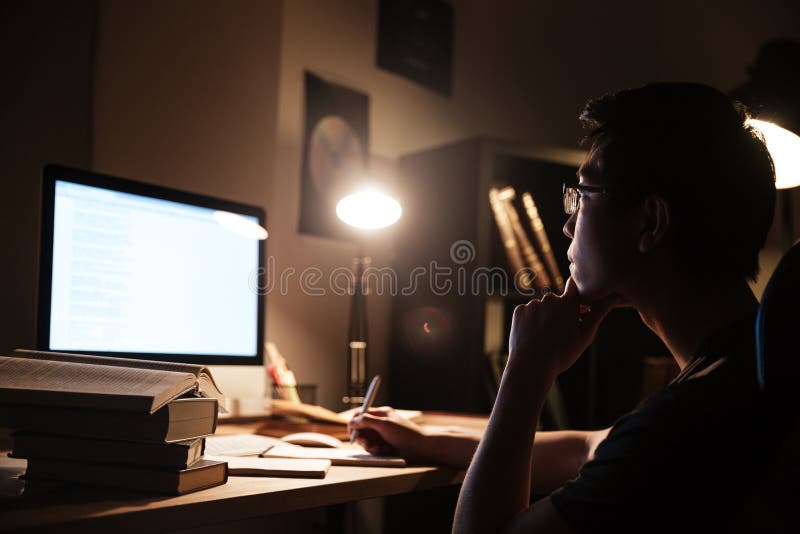 Pensive Man Writing and Working with Computer in Dark Room Stock Image ...