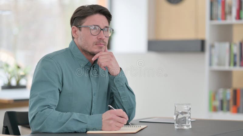 Pensive Middle Aged Man Writing at Work Stock Image - Image of book ...