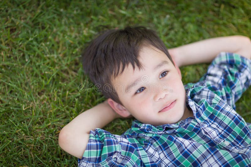 Thoughtful Mixed Race Chinese and Caucasian Young Boy Relaxing O Stock ... Thoughtful Mixed Race Chinese and Caucasian Young Boy Relaxing O Stock ...