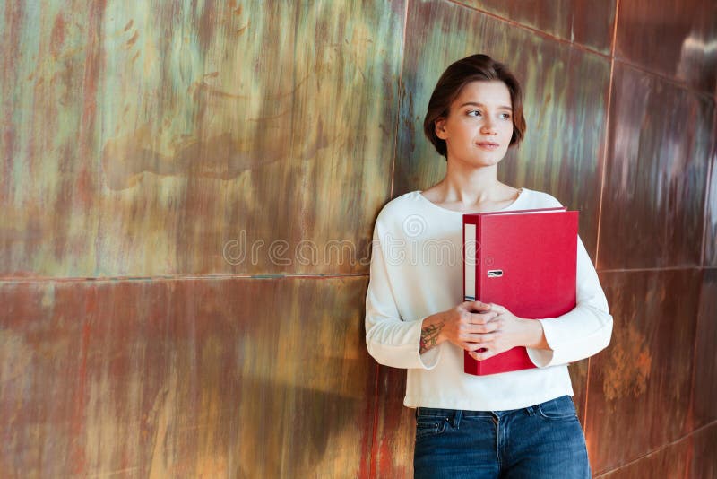 Pensive Pretty Young Woman Holding Red Ring Binder Folder Stock Photo ...