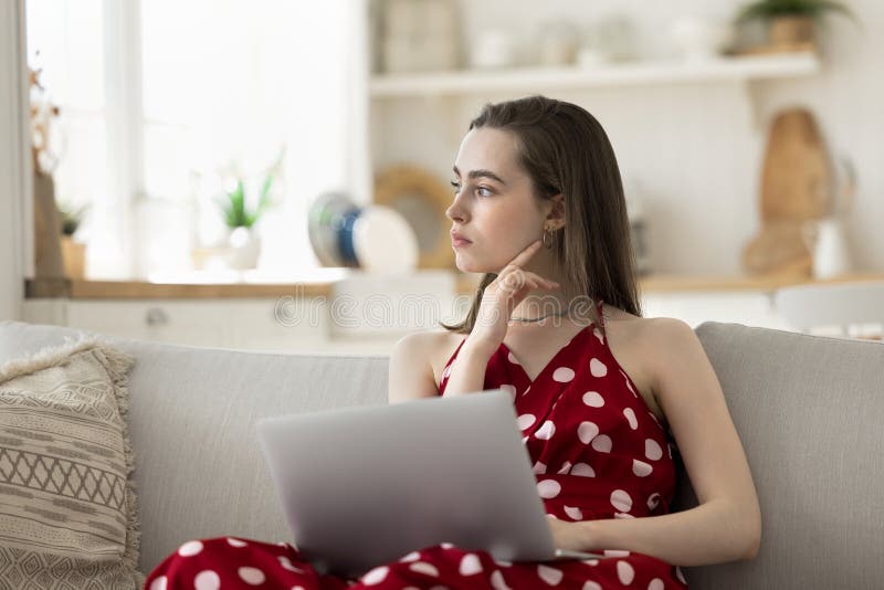 Pensive Pretty Young Woman Sit on Couch with Laptop Stock Photo - Image ...
