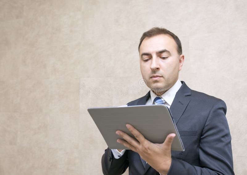 Pensive and Serious Businessman Looking Message in Tablet Computer ...