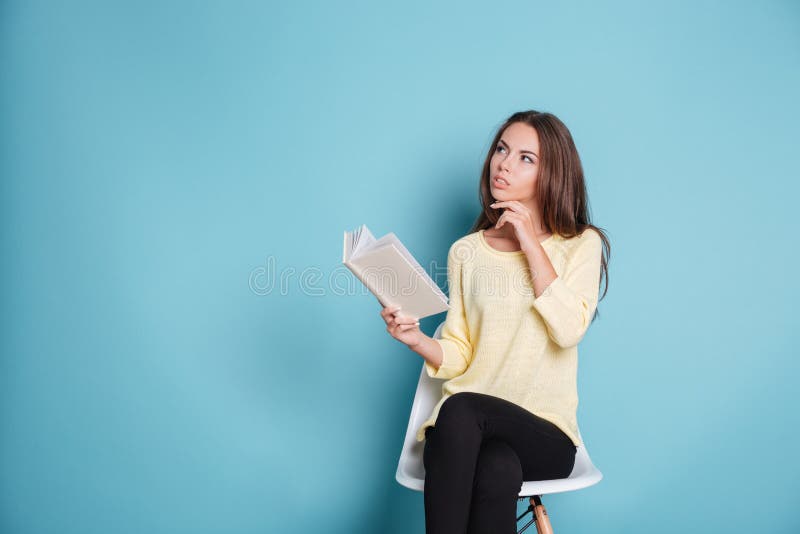 Pensive Smart Young Girl Thinking about Something Over Blue Background ...