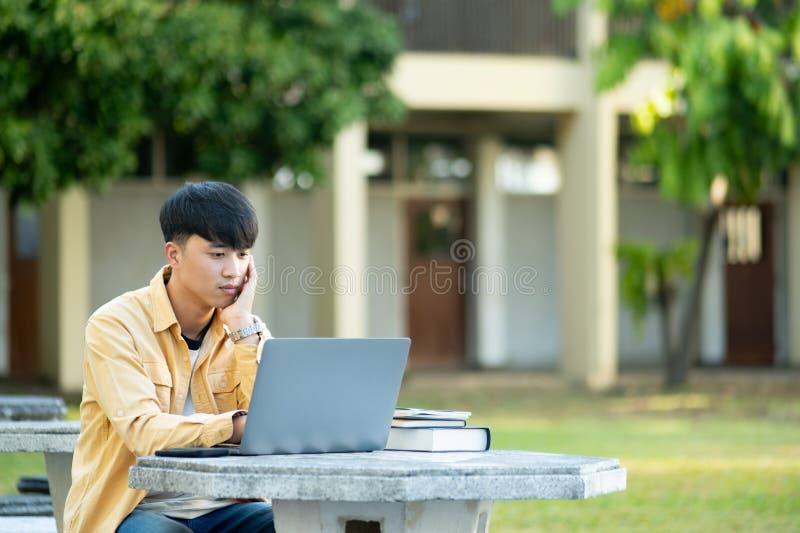 Pensive Student with Laptop Outdoors on University Grounds Stock Image ...