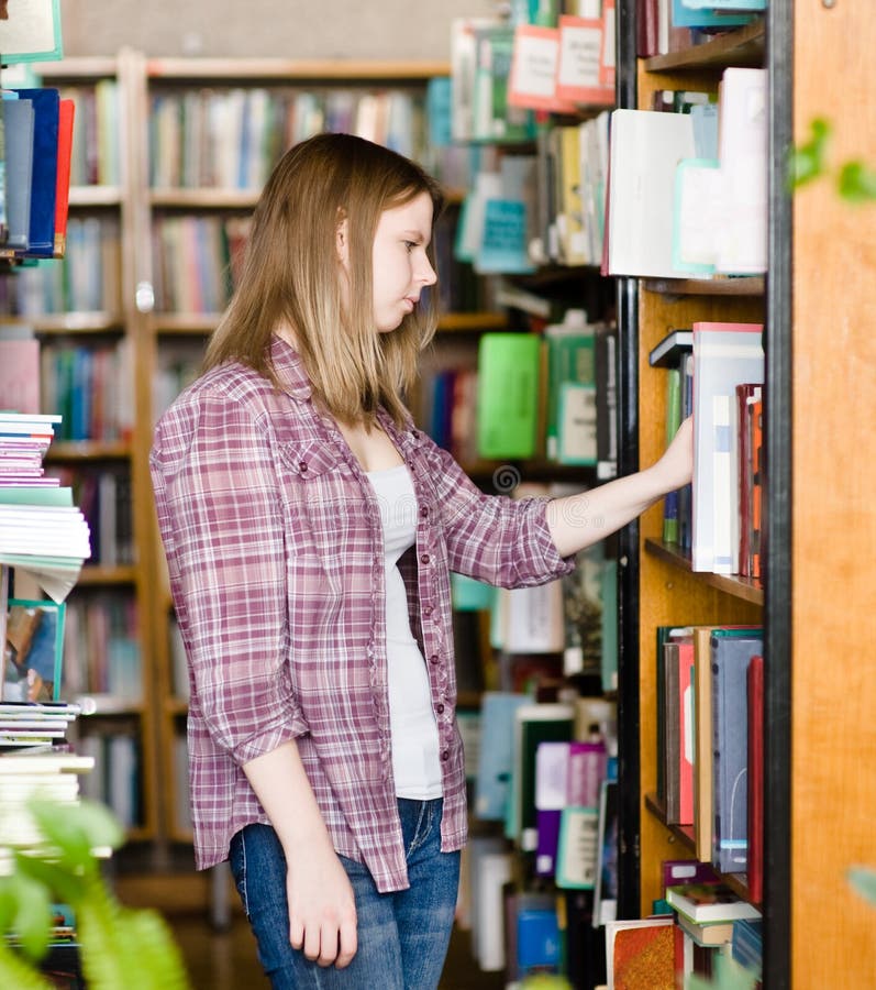 Pensive Student in the Library Surrounded by Books Stock Photo - Image ...