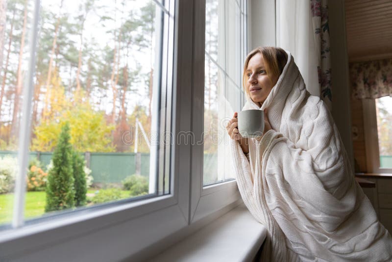 Pensive Woman Drinking Hot Herbal Tea at Home, Thinking, Looking Out ... Pensive Woman Drinking Hot Herbal Tea at Home, Thinking, Looking Out ...