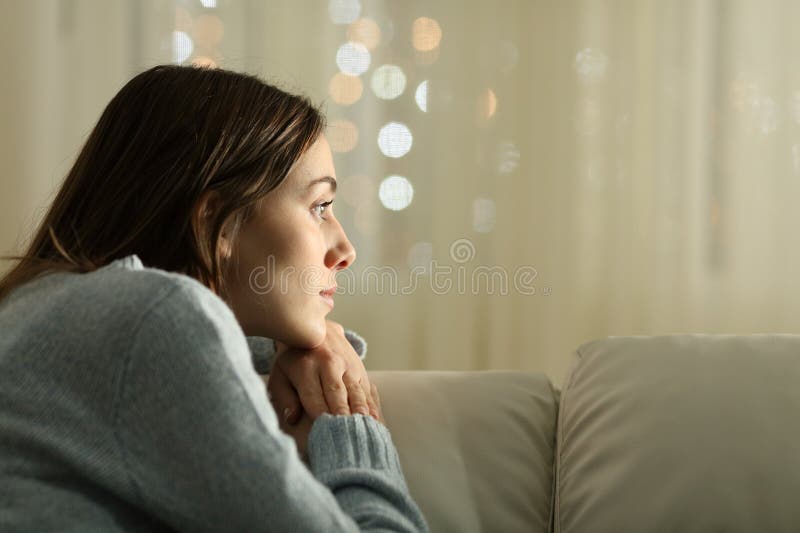 Pensive Woman Looking Away in the Night on a Couch Stock Image - Image ...