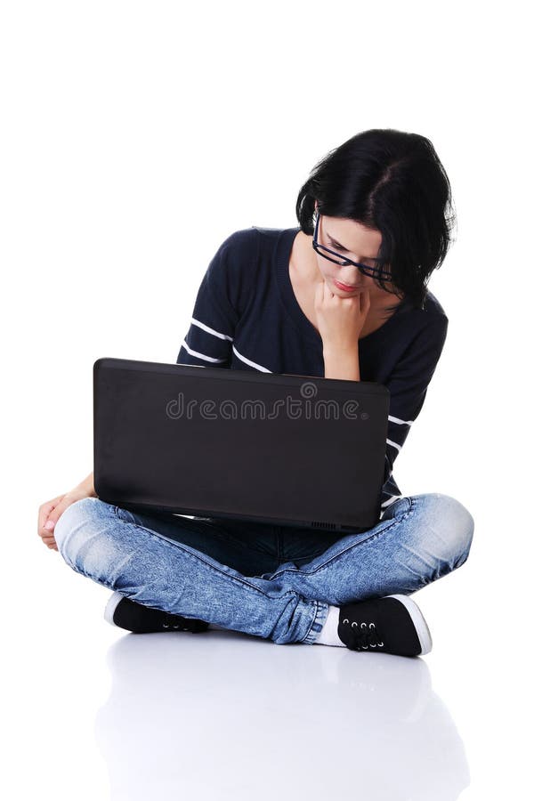 Pensive Woman Sitting Cross-legged with Laptop Stock Image - Image of ...