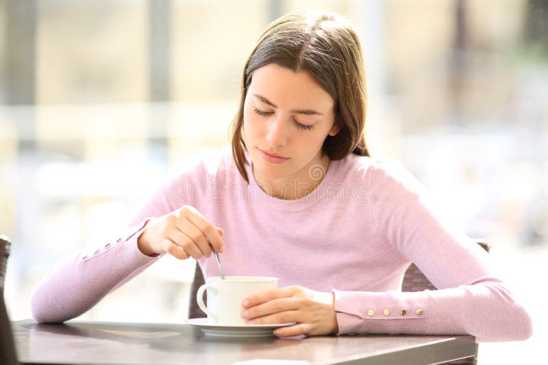 Pensive Woman Stirring Coffee in a Restaurant Stock Photo - Image of ...