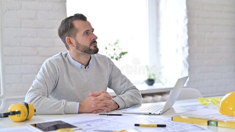Pensive Young Architect Thinking and Wondering in Office Stock Photo ...