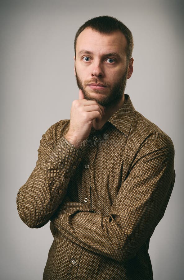 Pensive Young Man with Beard Looking at Camera Stock Photo - Image of ...