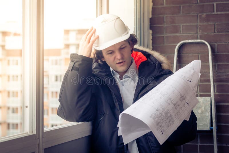 Pensive Young Man Builder in Hard Hat Standng and Thinking. Soft Focus ...