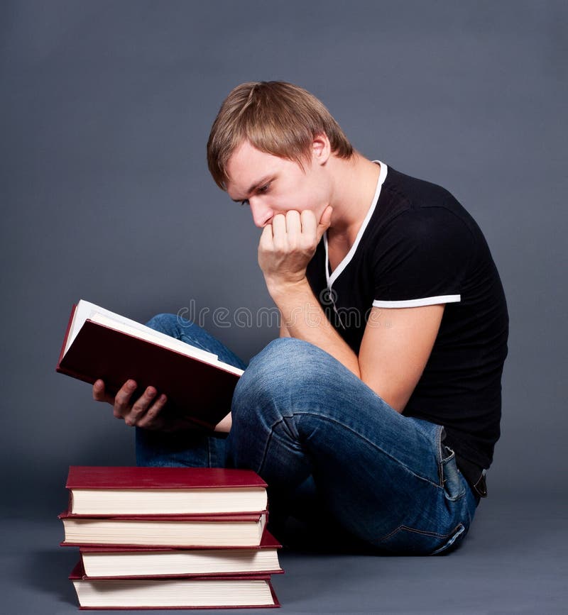 Pensive Young Man Studying on a Stack of Books Stock Photo - Image of ...