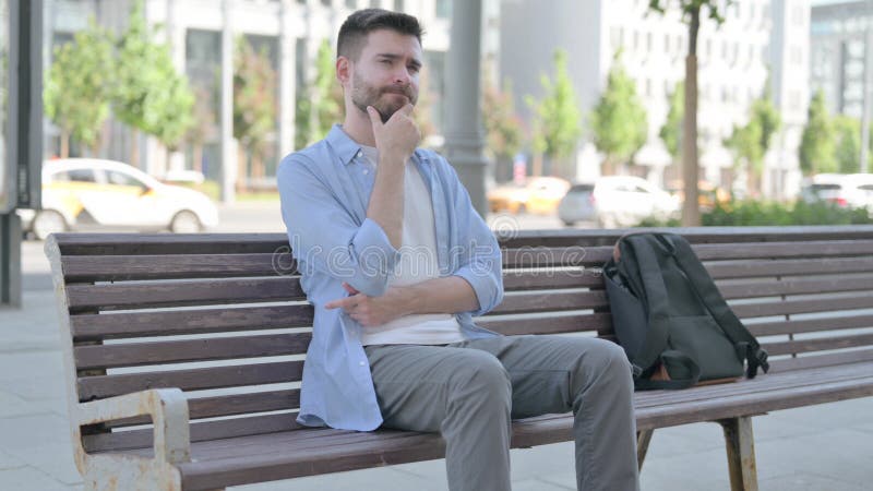 Pensive Young Man Thinking while Sitting on Bench Stock Photo - Image ...