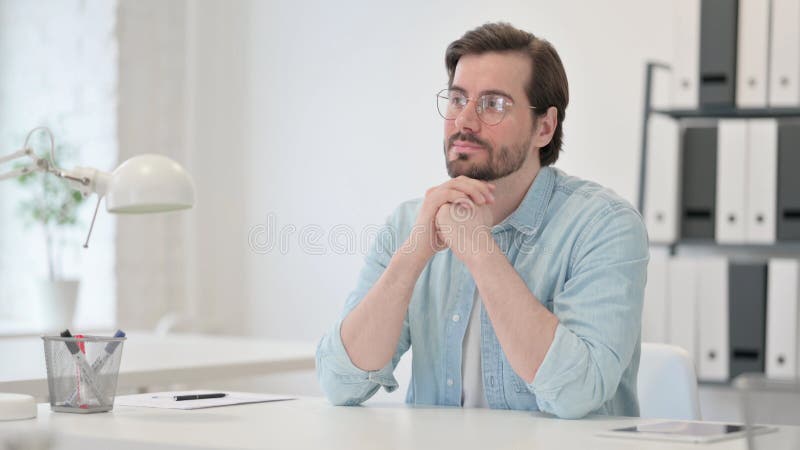 Pensive Young Man Thinking at Work Stock Photo - Image of working ...
