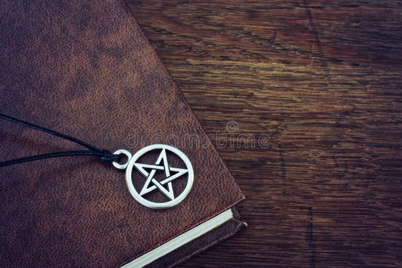 Pentagram pendant and book stock photo. Image of gothic - 55913200