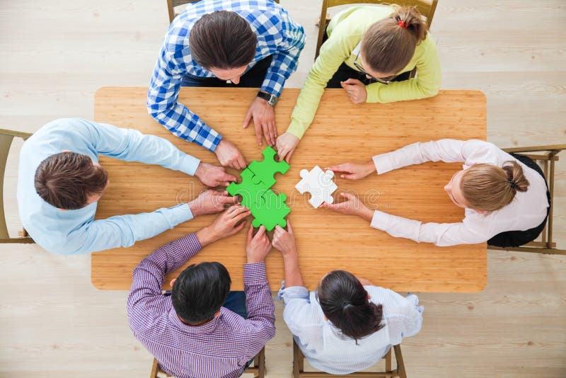People Assembling Jigsaw Puzzle Stock Photo - Image of cooperation ...