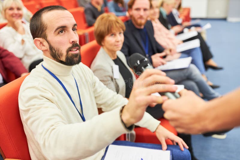 People in Audience Asking Question with Microphone at Business ...