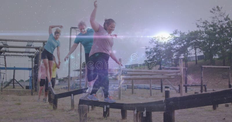People Balancing on Outdoor Obstacle Course with Glowing Light ...