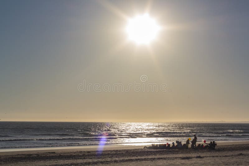People on beach at sunset stock image. Image of people - 149634263