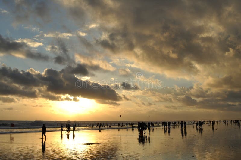 People on beach at sunset stock photo. Image of clouds - 34341406