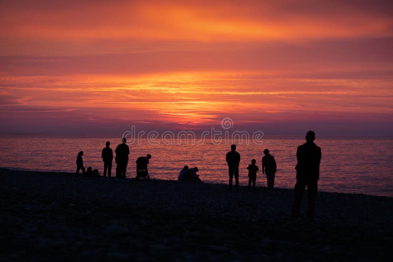 People on a Beach Watching Sunset Stock Photo - Image of beach, sand ...