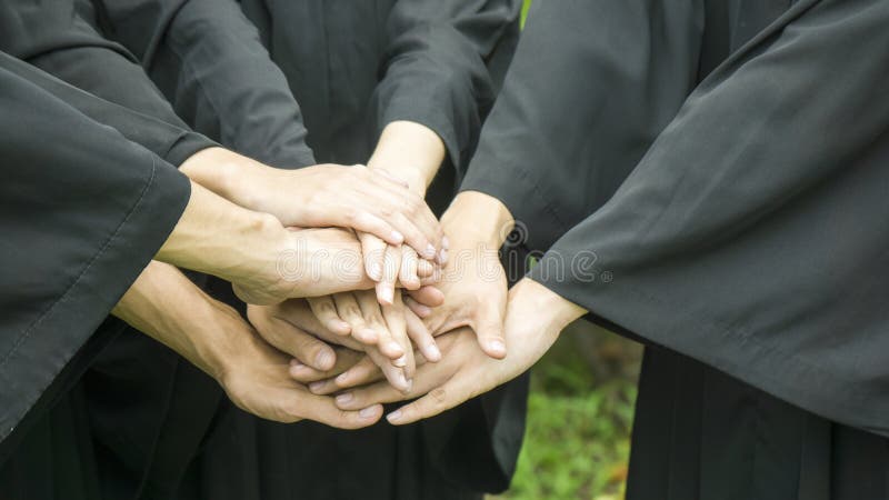 People with Black Gowns Join Hand in Grouping. Stock Image - Image of ...