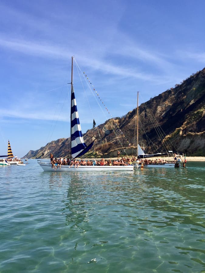 People on a Boat with Striped Sail Editorial Photography - Image of ...