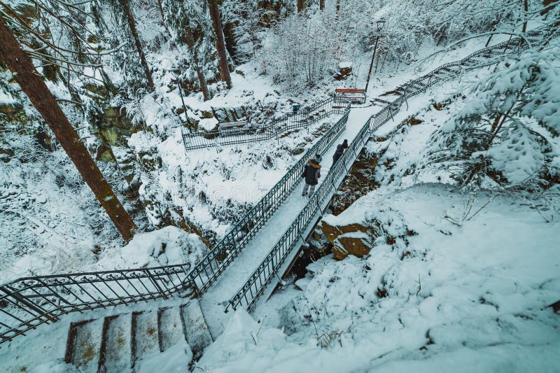 People on the Bridge in the Snowy Mountain Park Stock Photo - Image of ...
