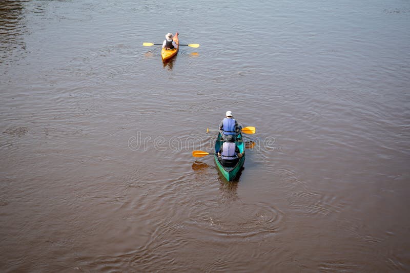 People Canoeing and Kayaking on River during Leisure Activity with Calm ...