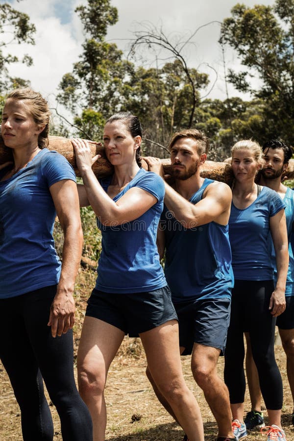 People Carrying a Heavy Wooden Log during Boot Camp Stock Photo - Image ...
