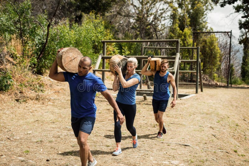 People Carrying Heavy Wooden Logs during Obstacle Course Stock Photo ...
