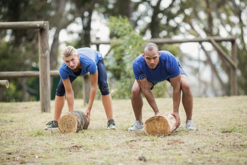 People Lifting Heavy Wooden Logs Obstacle Course Stock Photos - Free ...