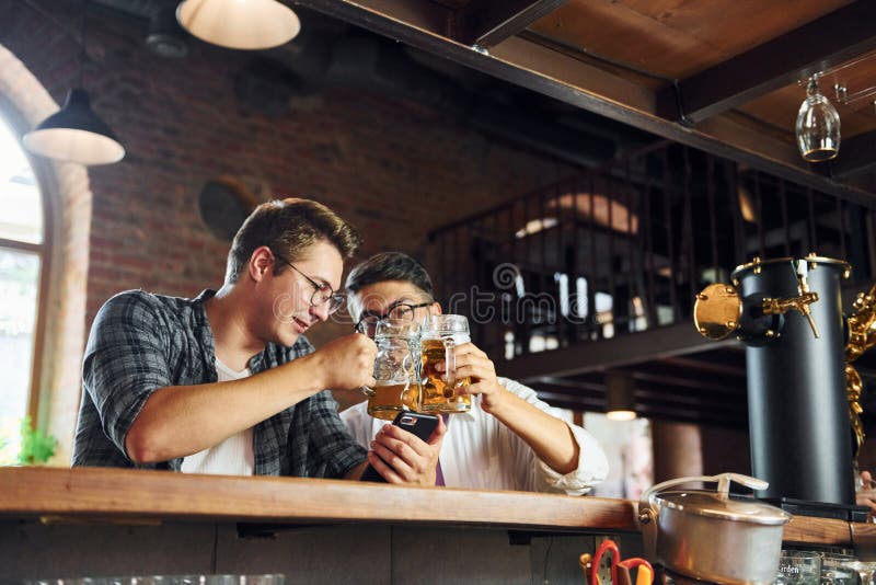 People in Casual Clothes Sitting in the Pub and Having Conversation ...