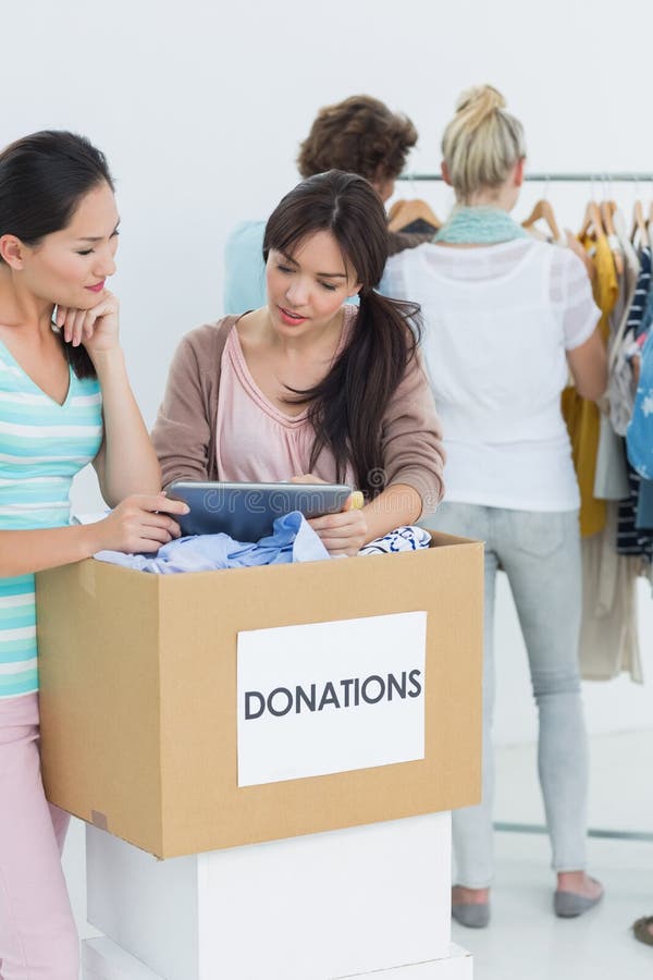 People with Clothes Donation while Using Digital Tablet Stock Image ...