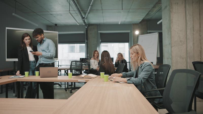 People Collaborating in an Office with Documents and Technology in Slow ...