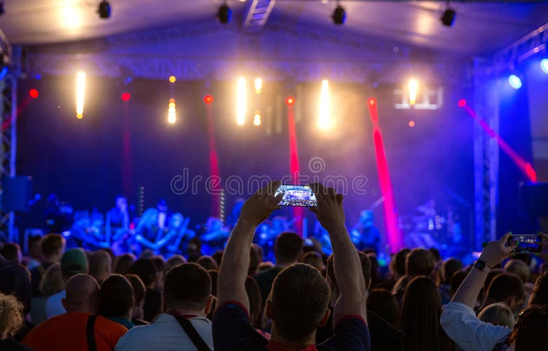 People at Concert Shooting Video or Photo on Stage Editorial Photo ...
